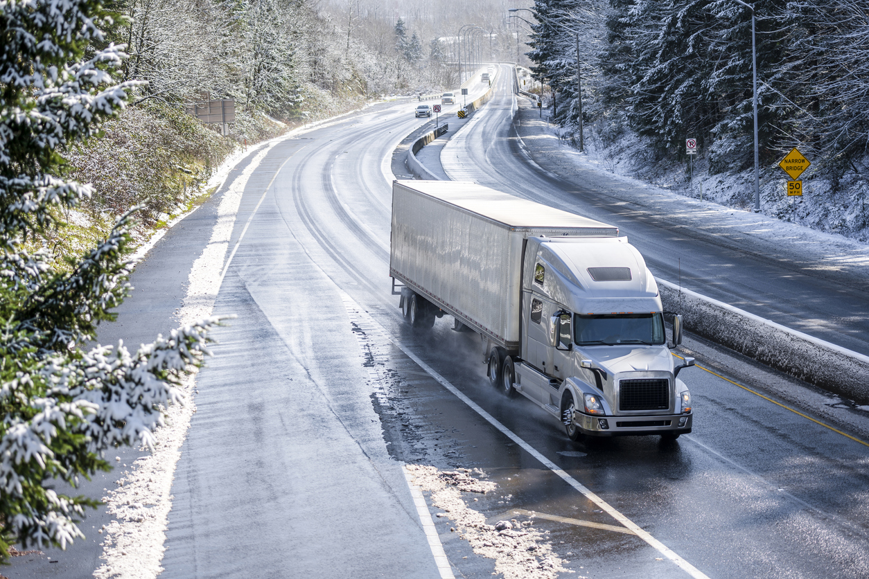 Big rig semi truck with semi trailer driving on winter snowy highway ...
