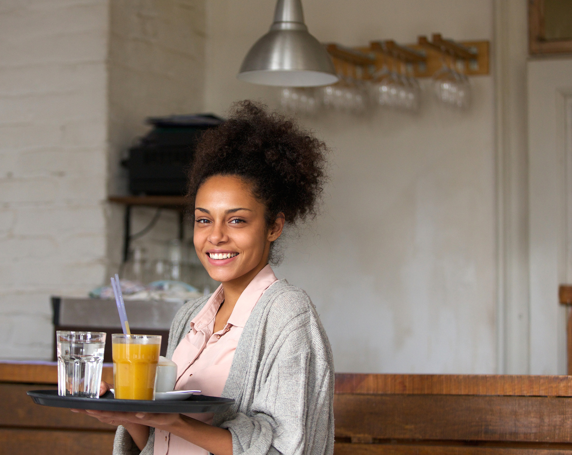 Smiling waitress holding tray of drinks in restaurant – ASKMigration ...