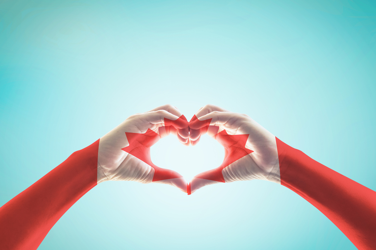 Canada flag pattern on people hands in heart shape for national public ...